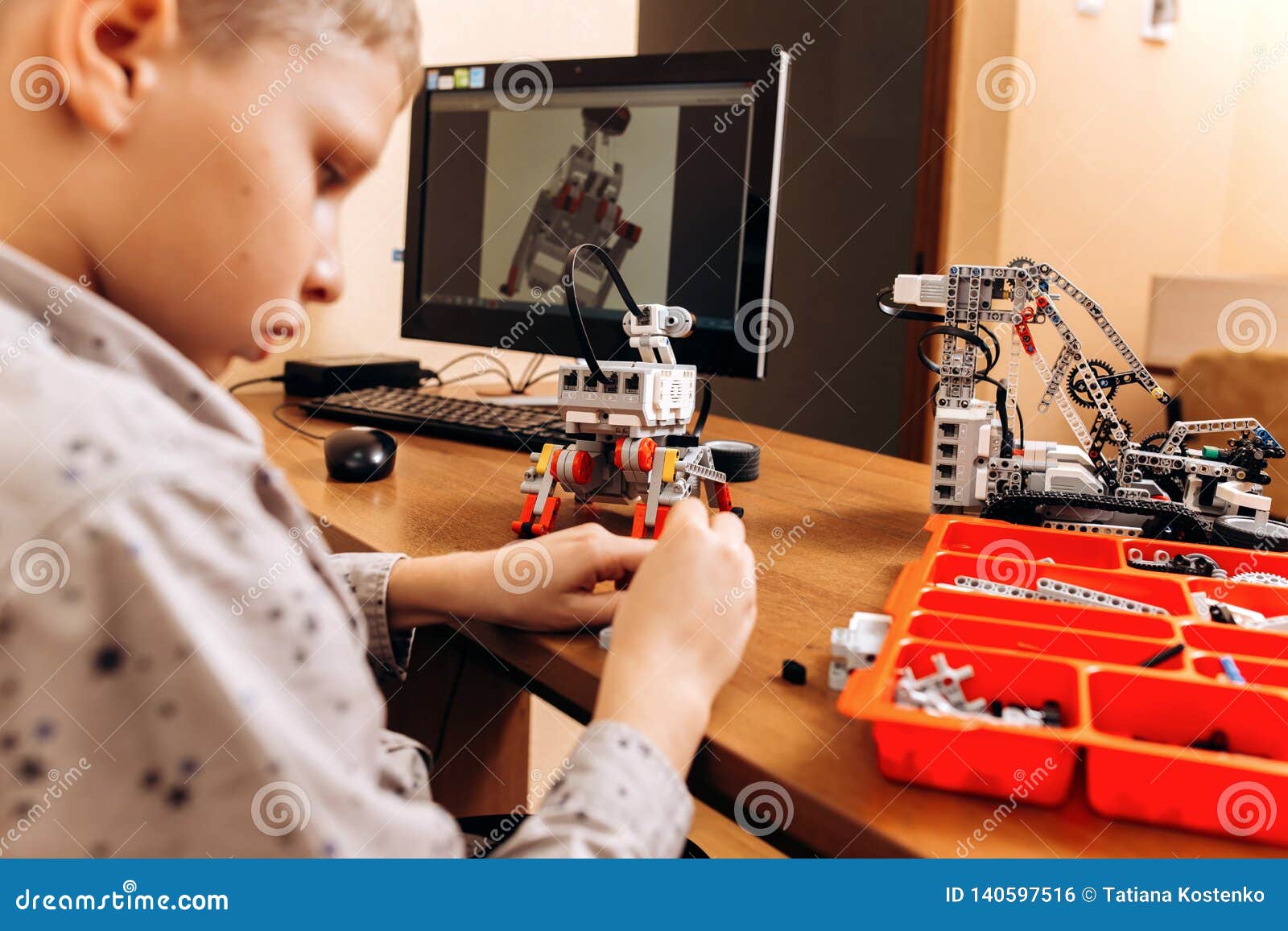 Smart Boy Dressed in Gray Shirt Makes a Robot from the Robotic ...