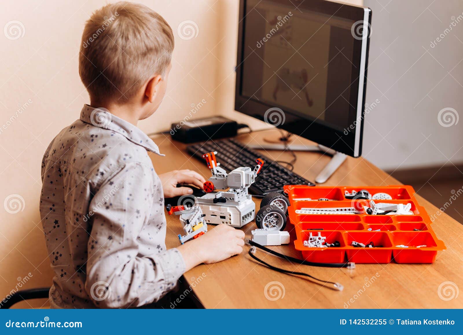 Smart Boy Dressed in Gray Shirt Makes a Robot from the Robotic ...