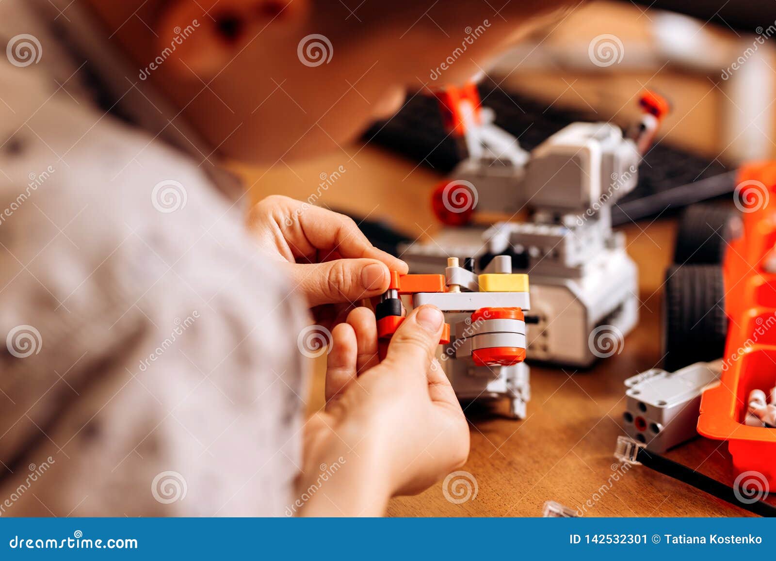 Smart Boy Dressed in Gray Shirt Makes a Robot from the Robotic ...