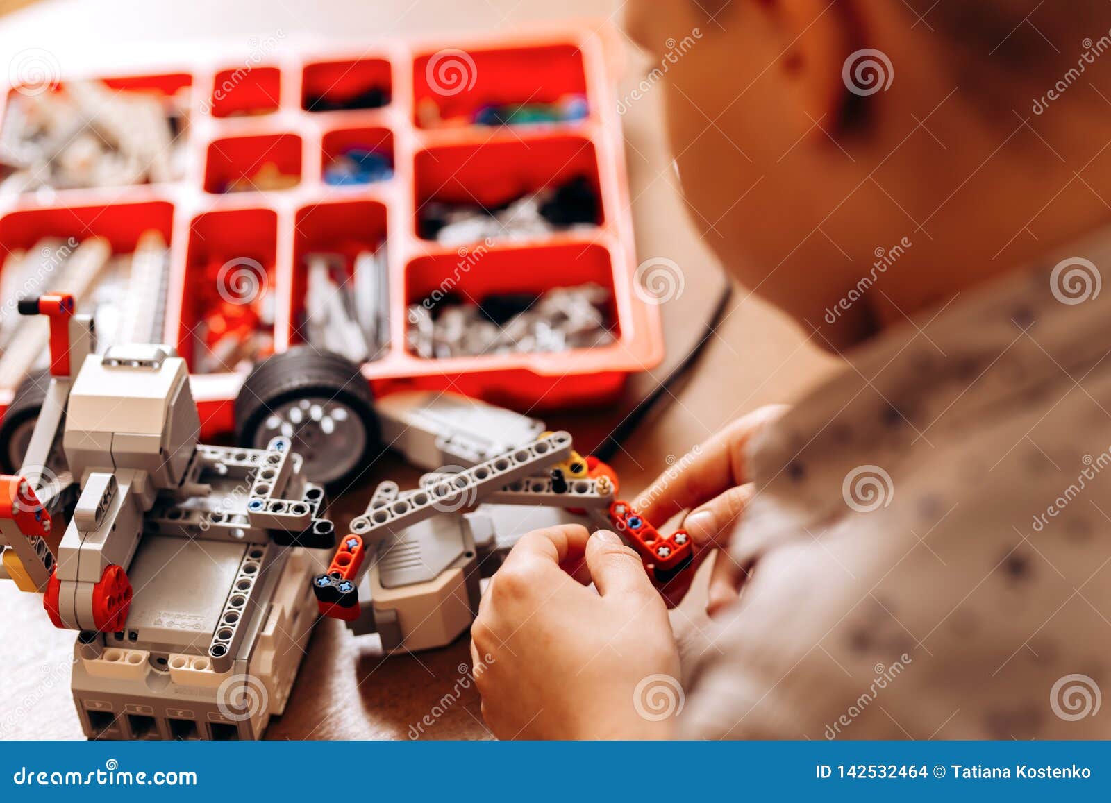 Smart Boy Dressed in Gray Shirt Makes a Robot from the Robotic ...