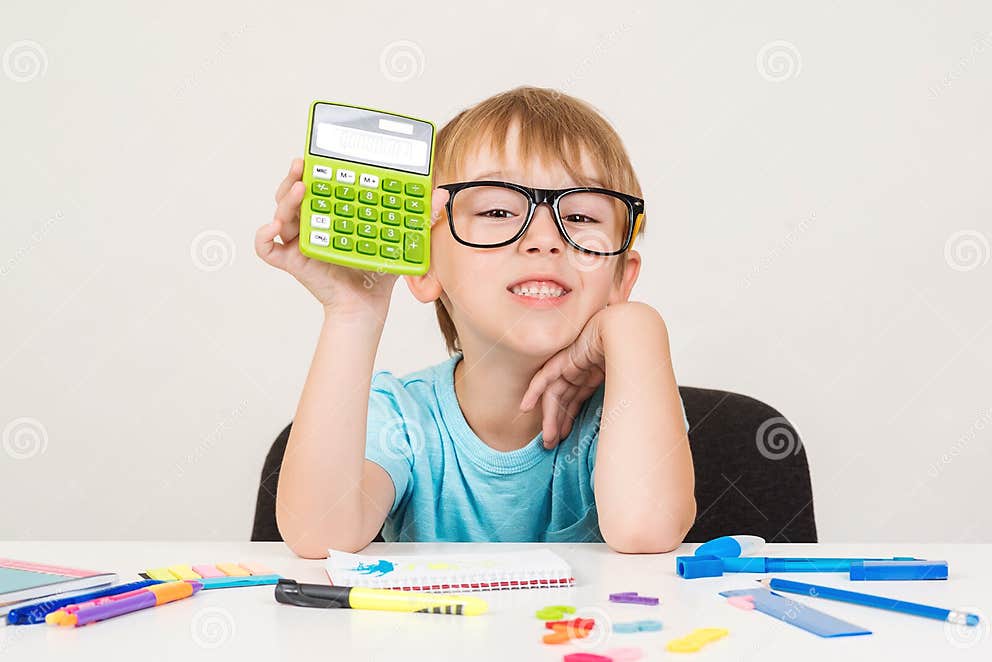 Smart Boy Using Calculator. Kid in Glasses Figuring Out Math Problem ...