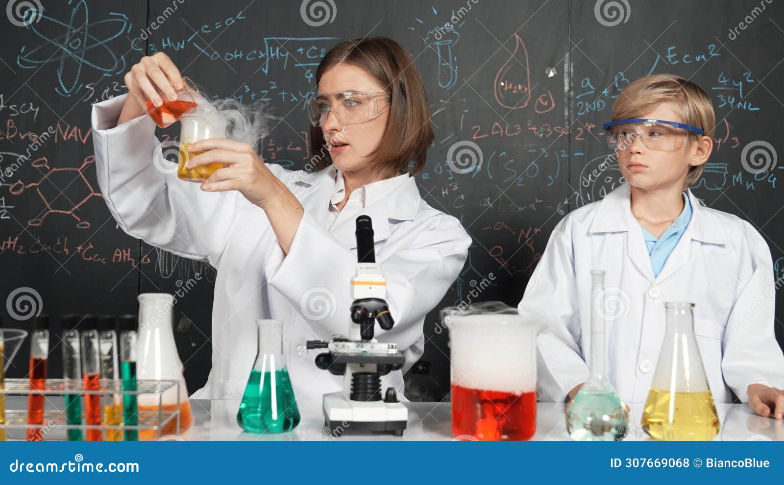 Smart Caucasian Teacher Mixing Chemical Liquid in Science Laboratory ...