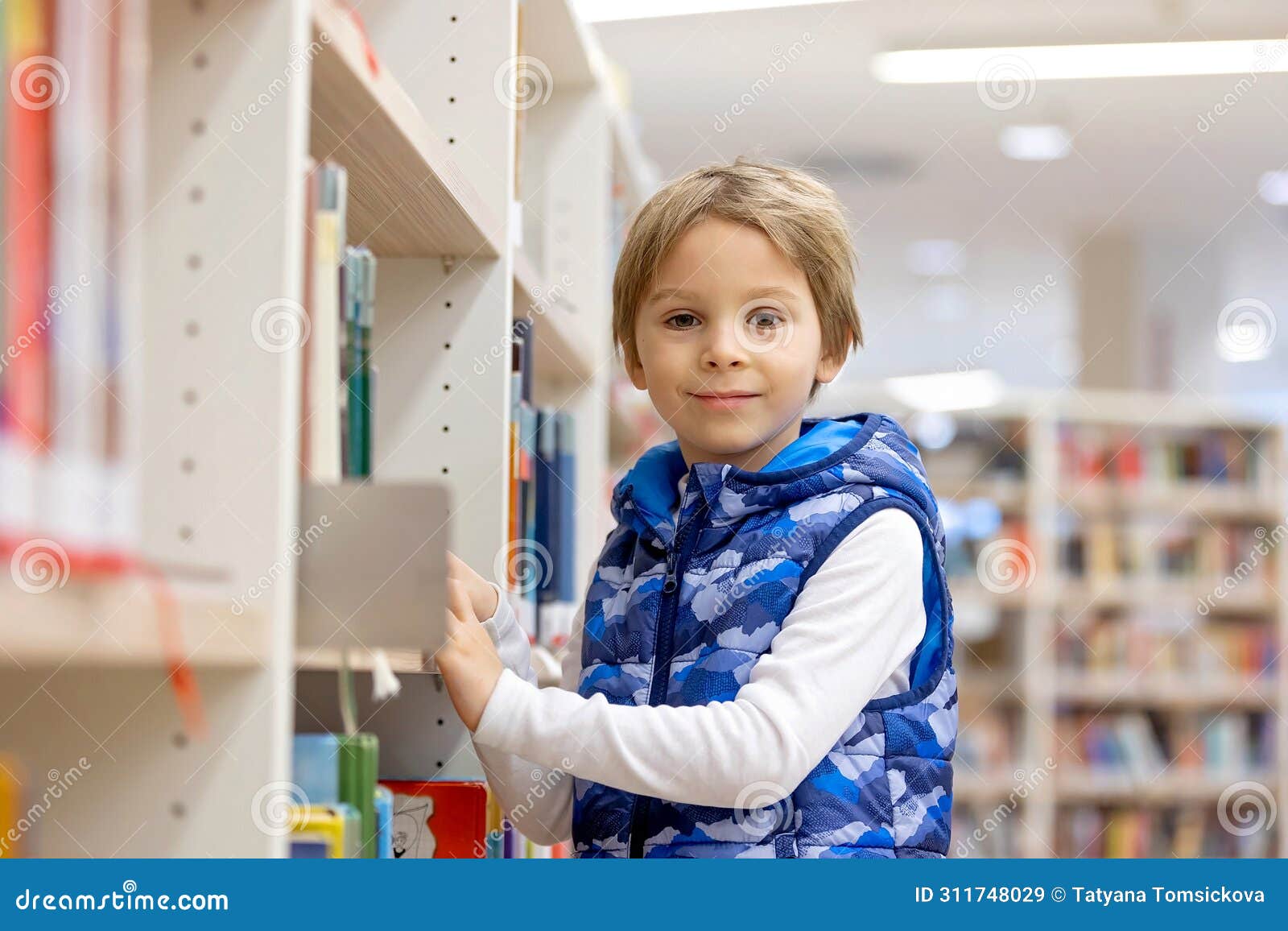 Smart Child, School Boy, Educating Himself in a Library, Borrowing ...