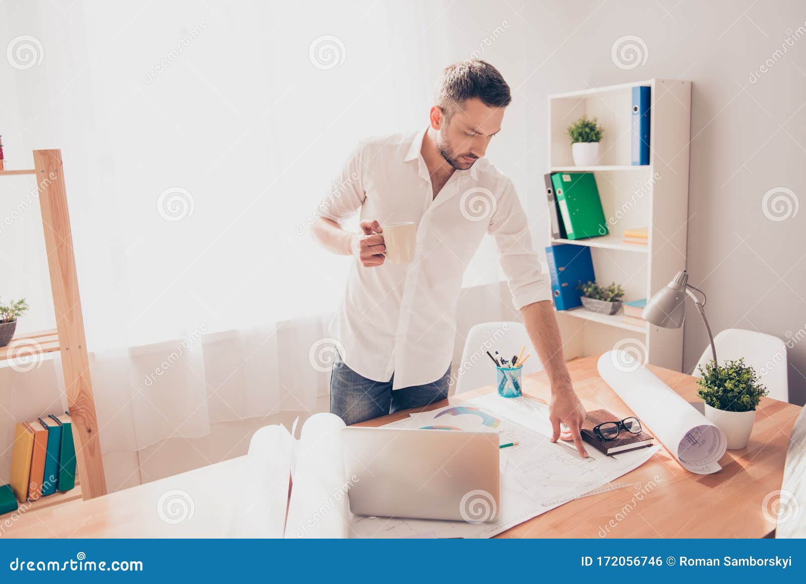 Smart Concentrated Engineer Working on Plan and Drinking Coffee Stock ...