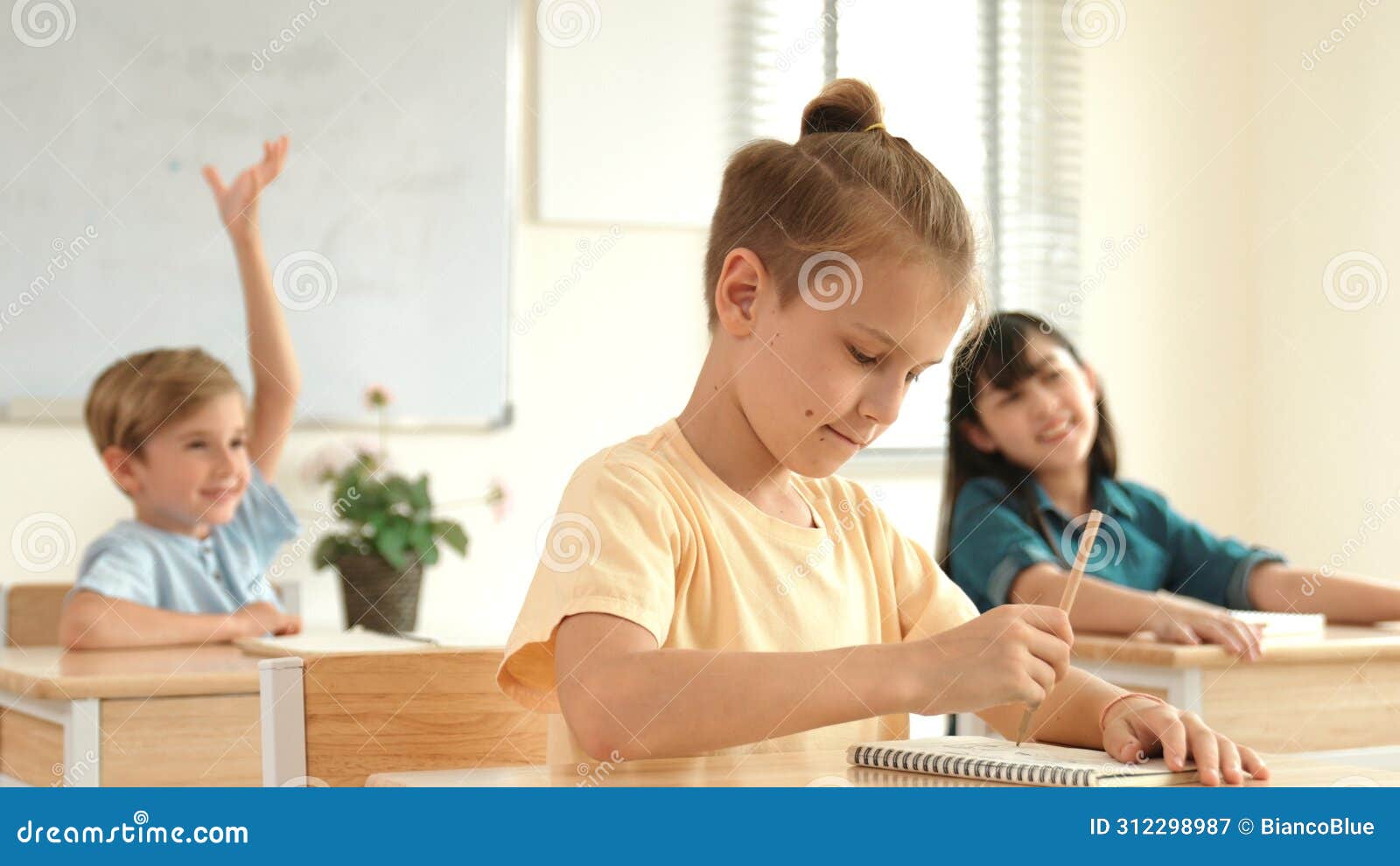 Smart Elementary Student Looking at Teacher while Attend in Classroom ...