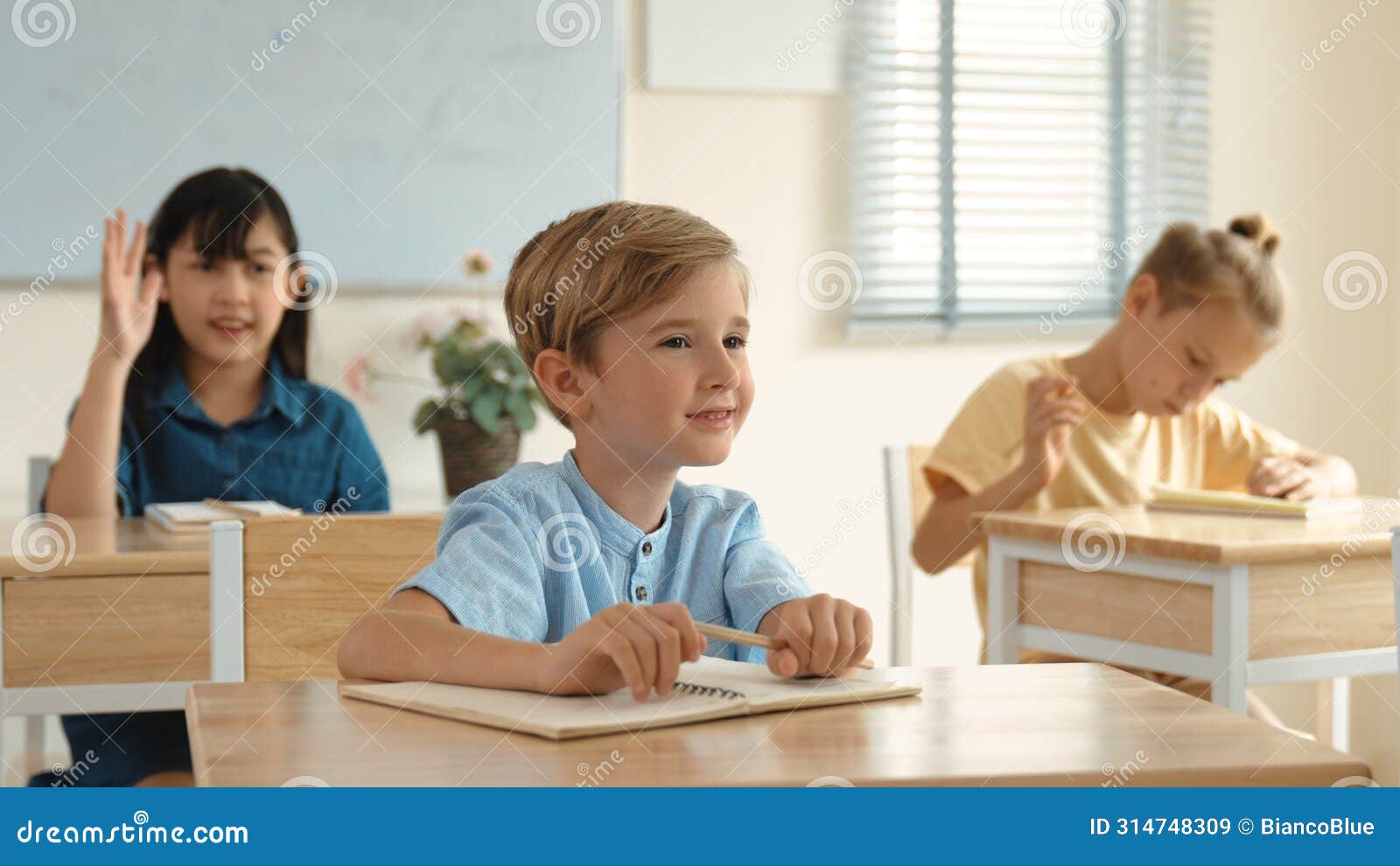 Smart Elementary Student Looking at Teacher while Attend in Classroom ...