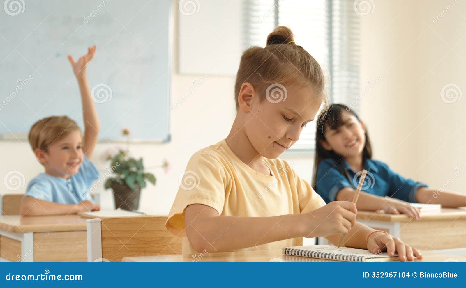 Smart Elementary Student Looking at Teacher while Attend in Classroom ...