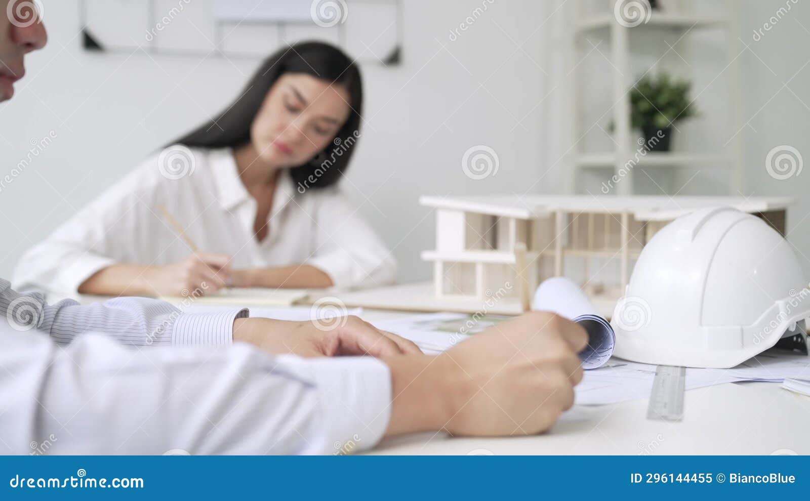 Smart Engineer Drawing Blueprint and Working Together with Coworker ...