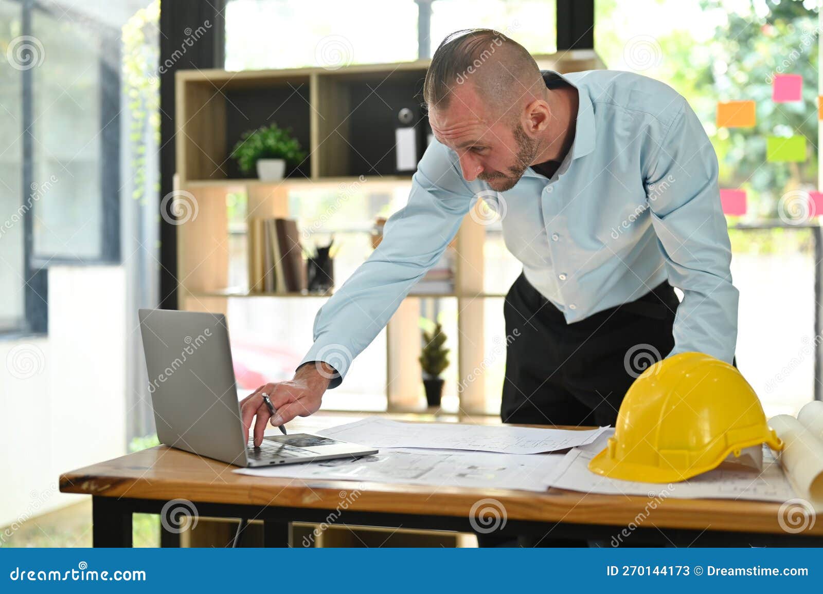 Smart Engineer Man in Shirt Using Laptop and Working with Blueprints ...