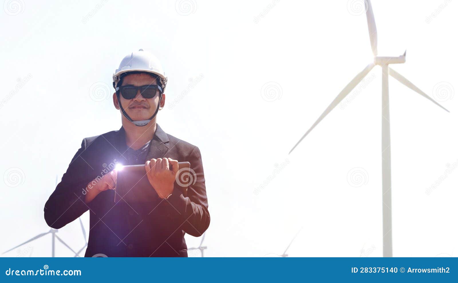 Smart Engineer Man Stands Using Tablet Front the Wind Turbines ...