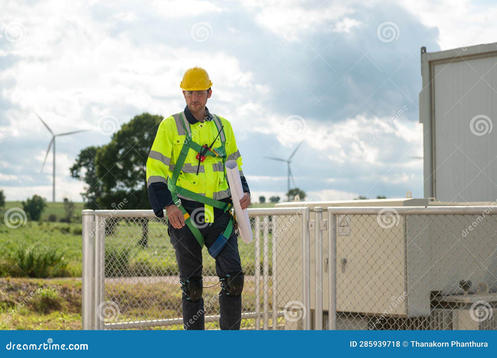 Smart Engineer with Protective Helmet Holding the Blueprint Working at ...