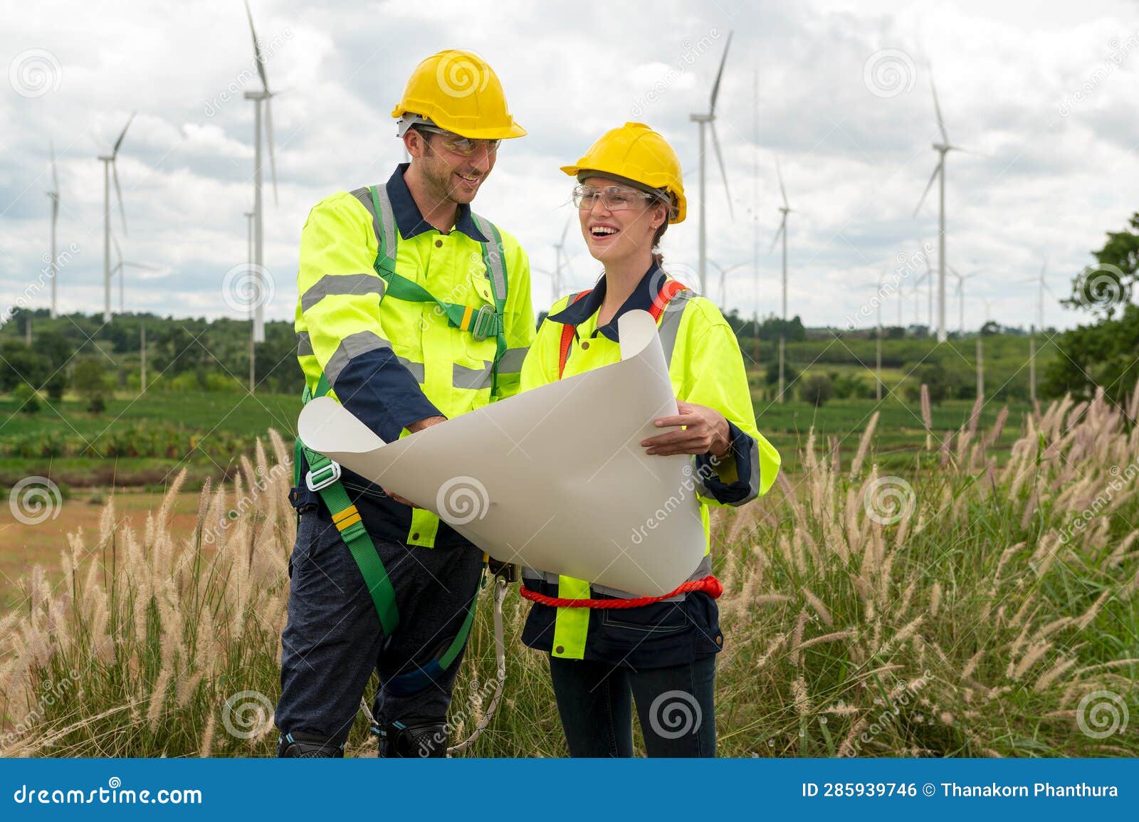 Smart Engineer with Protective Helmet Holding the Blueprint Working at ...
