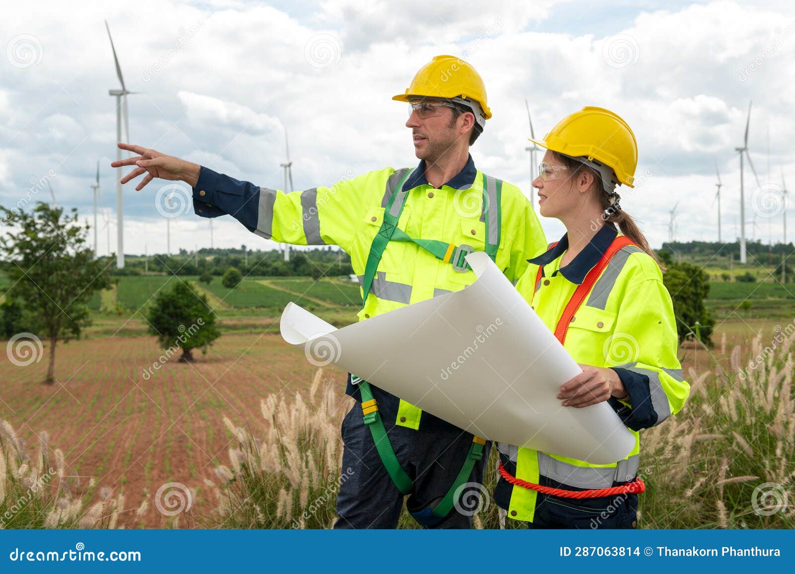 Smart Engineer with Protective Helmet Holding the Blueprint Working at ...