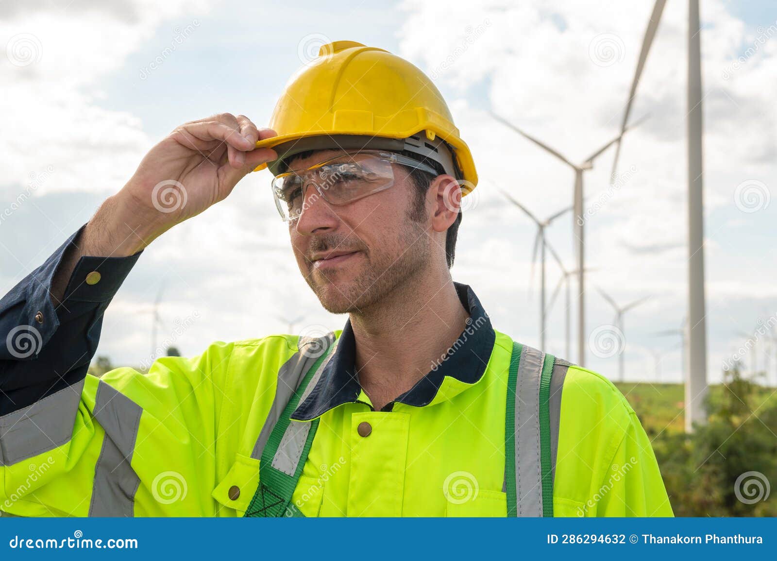 Smart Engineer is Putting a Protective Helmet on Head at Electrical ...
