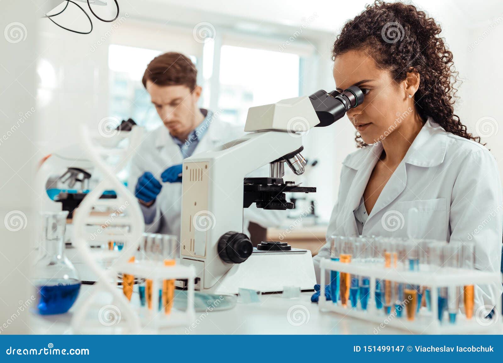 Smart Female Biologist Looking into the Microscope Stock Image - Image ...