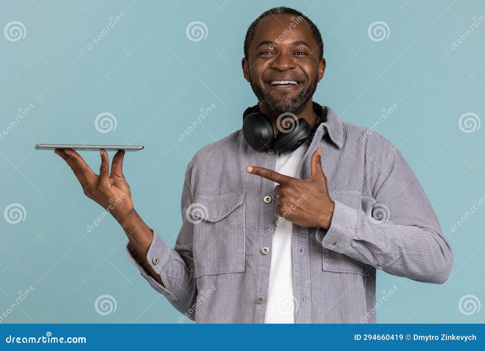 Smart Guy Pointing at Device Showing Tablet Design. Stock Image - Image ...
