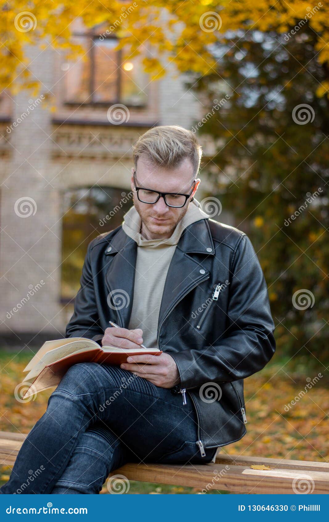 Smart Guy Writer in Casual Clothes Makes Notes in a Notebook and Sits ...