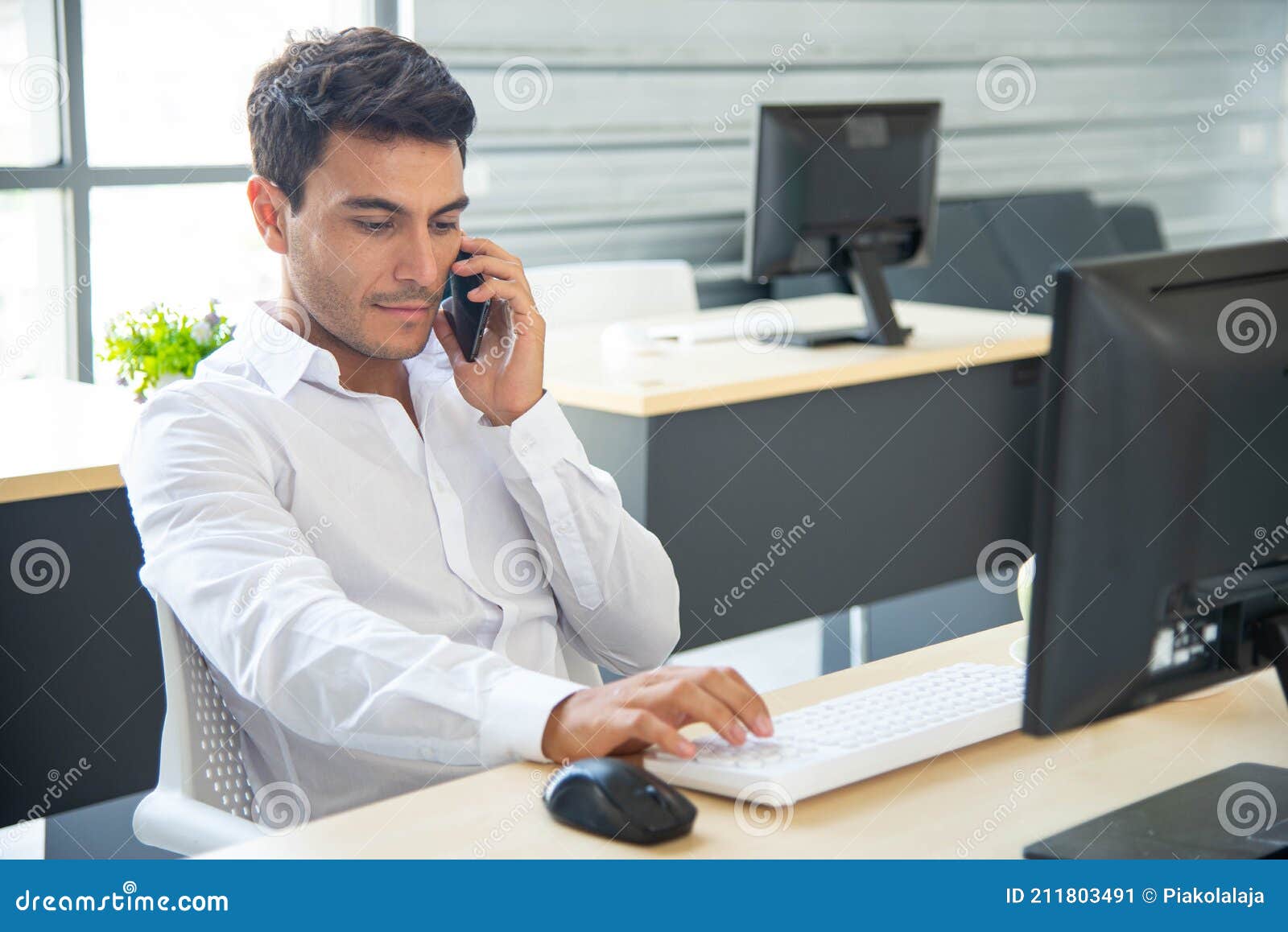 Smart and Happy Business Man Using Smartphone while Working with ...