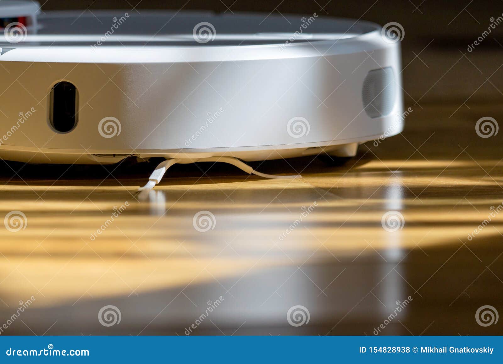 Smart Home. Robot Vacuum Cleaner Performs Automatic Cleaning of the ...