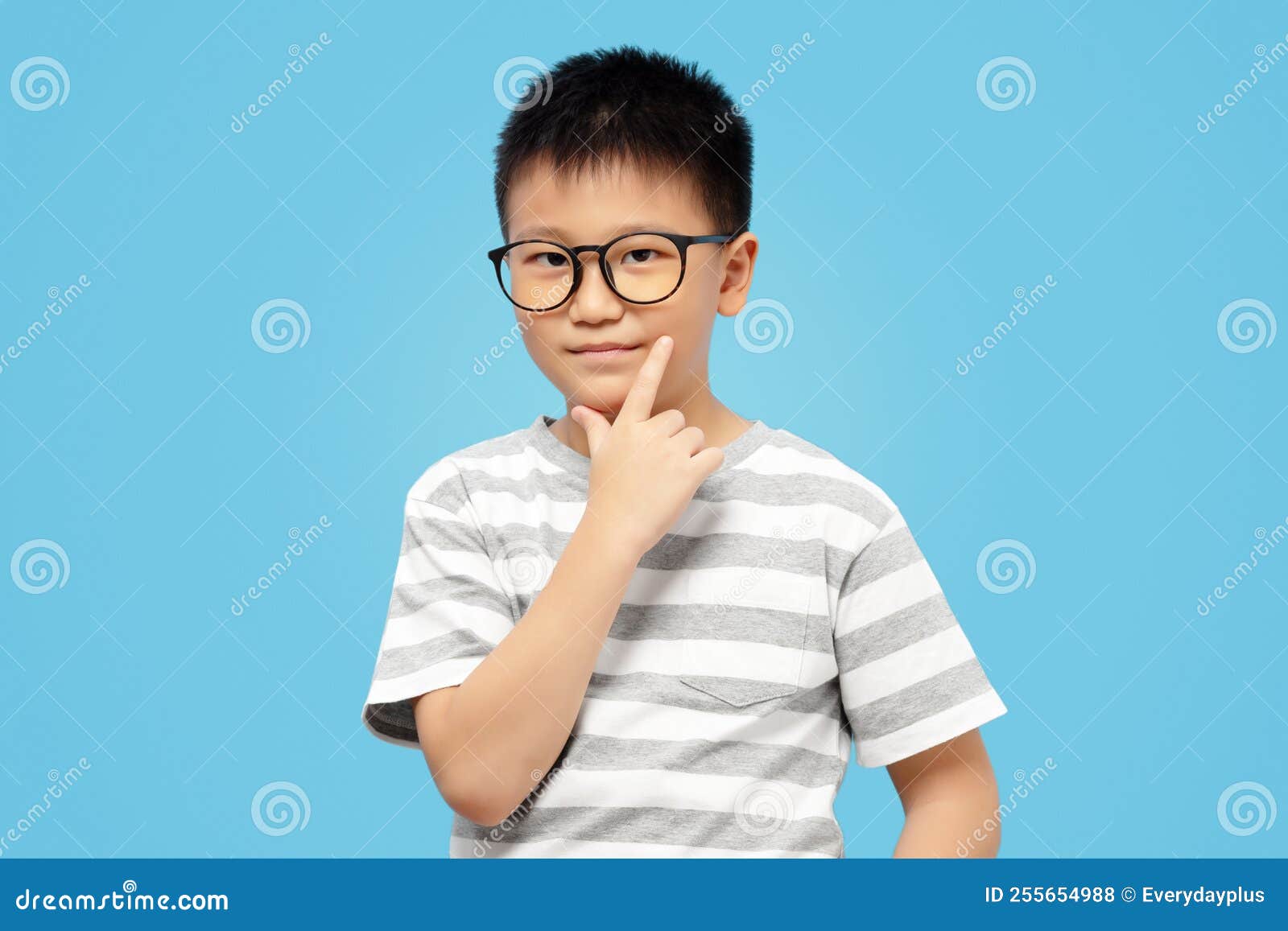 Smart Kid Thinking, Wearing Eyeglasses with Finger on Chin Stock Photo ...