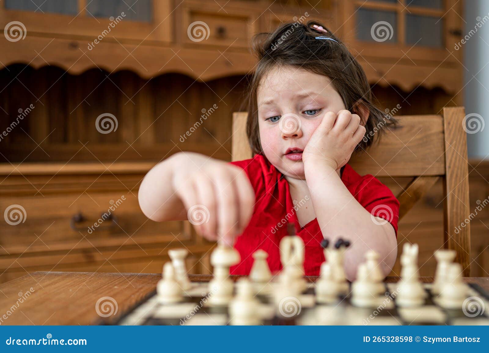 A Smart Little Girl Playing Chess Stock Photo - Image of entertainment ...