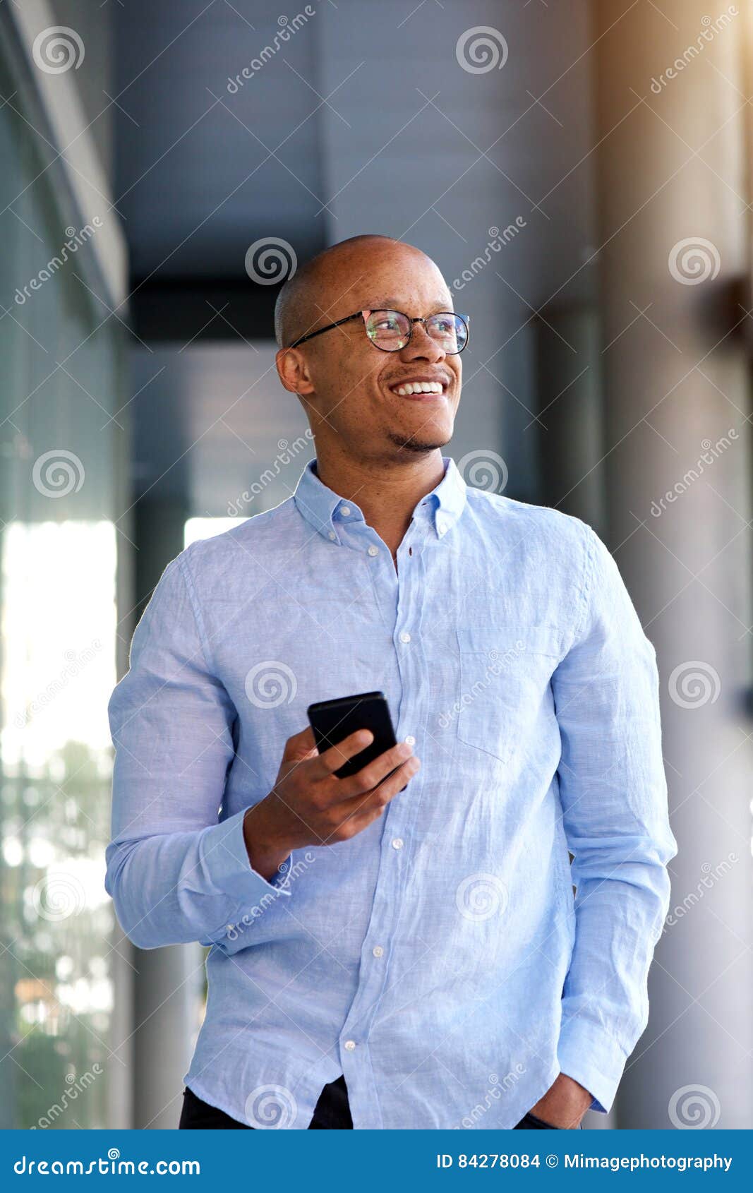 Smart Looking African Businessman Walking with Cellphone Stock Photo ...