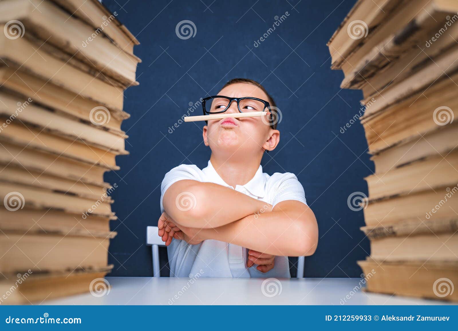 Smart Looking Boy Holding Pencil in His Mouth, Looking Away and Stock ...