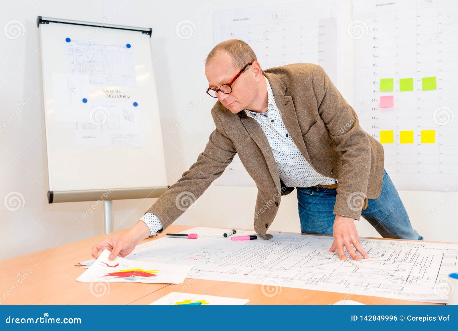 Architect Reaching for Document while Working on Blueprint Stock Photo ...