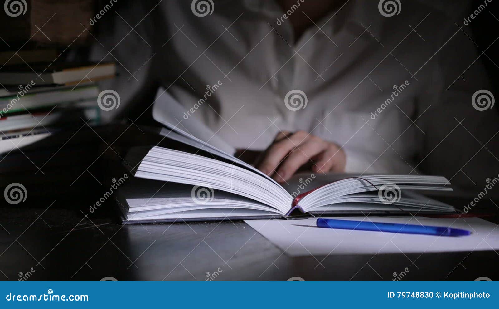 Smart Man Studying Late at Night, he is Sitting at Desk and Reading ...