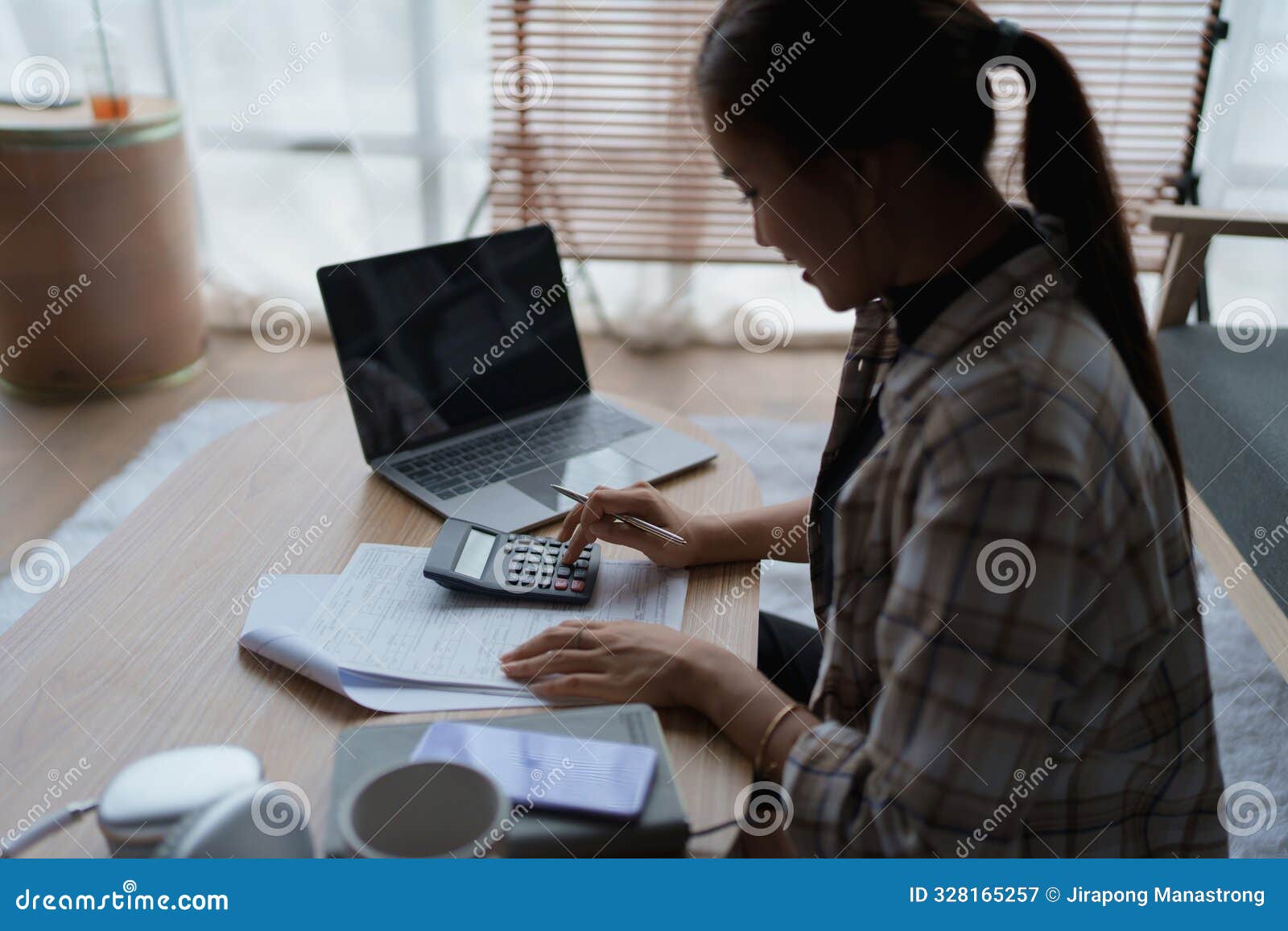 Smart Mortgage Planning Woman Using a Calculator To Make Calculations ...