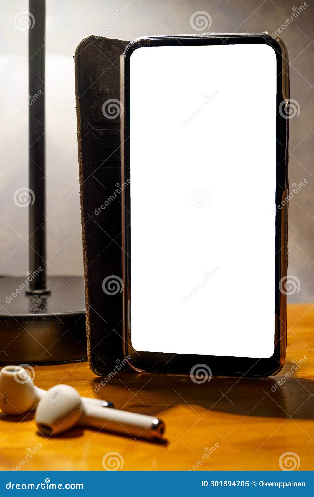 Smart Phone with Flip Case and Empty White Screen on Bedside Table ...