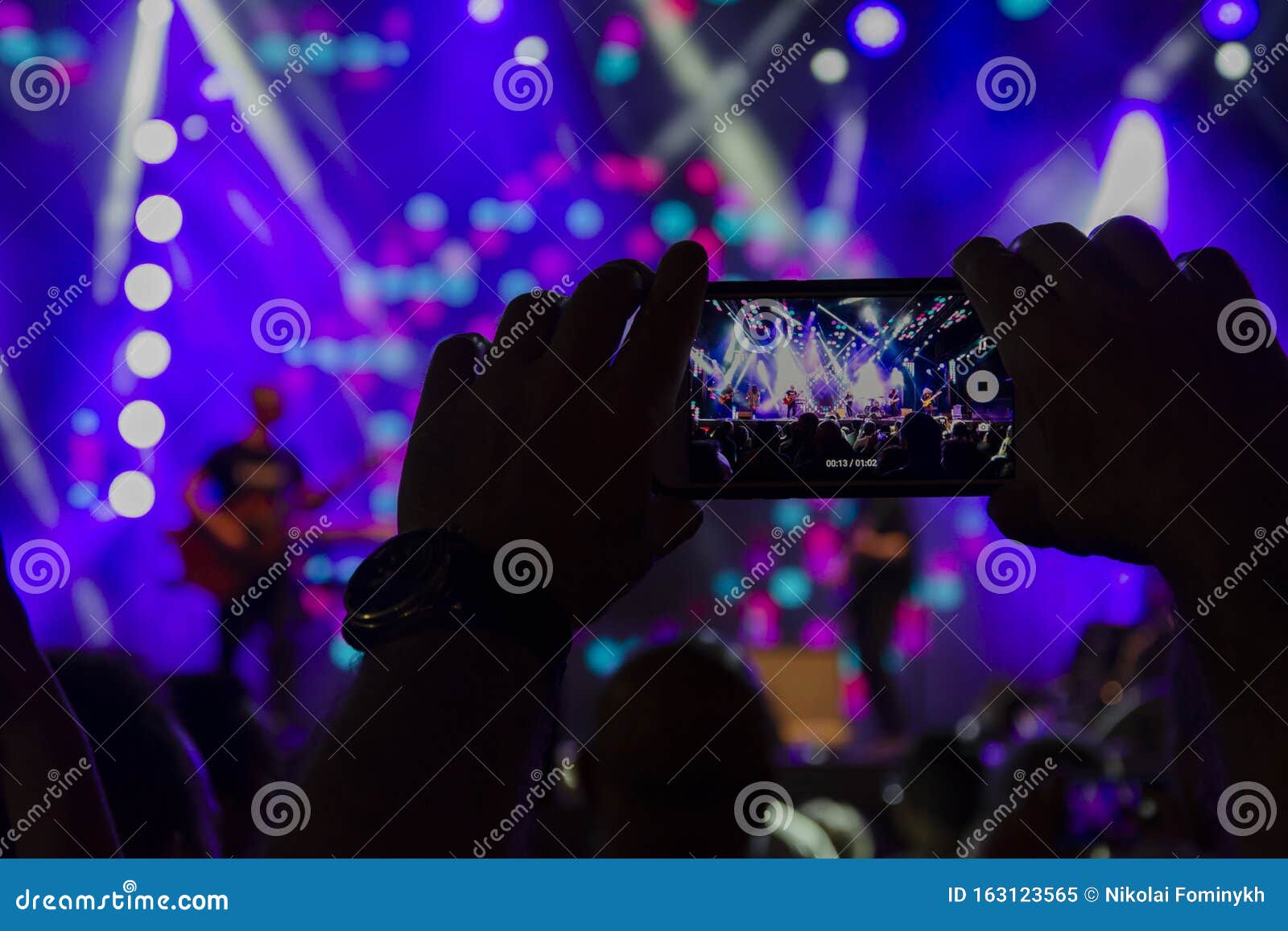 Smart Phone on the Hand during a Live Concert with Toned Special Effect ...