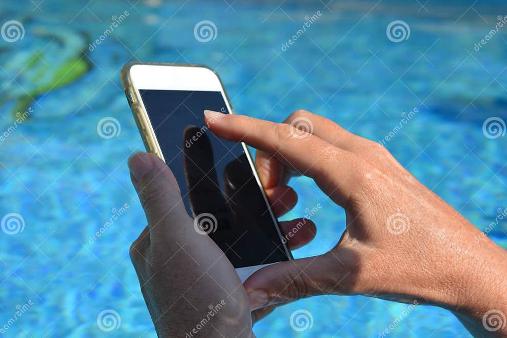 Using Technology, Using a Mobile Phone by a Swimming Pool in Summer ...