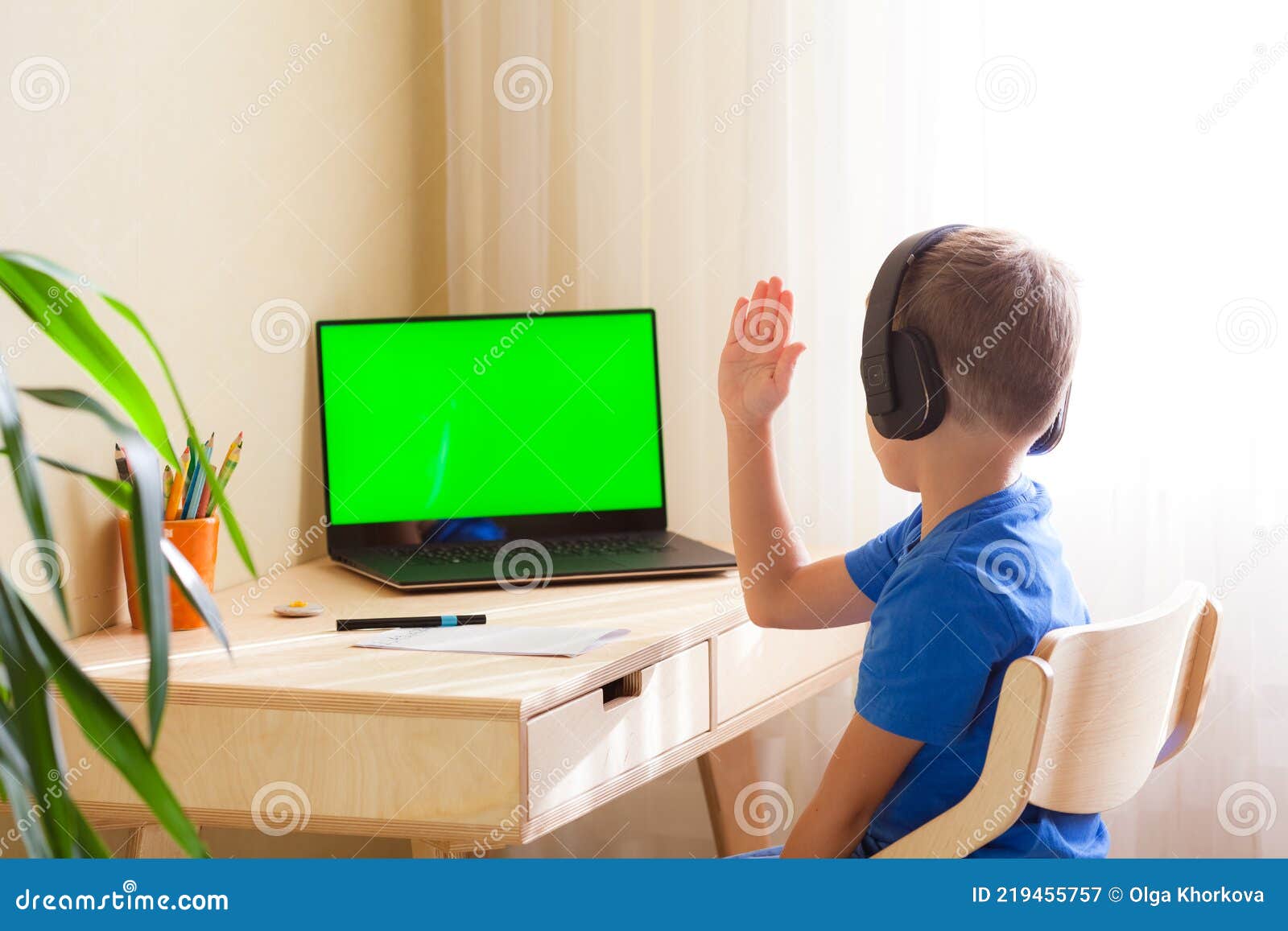 Smart School Boy Sits at the Table and Looks at the Computer. a Child ...