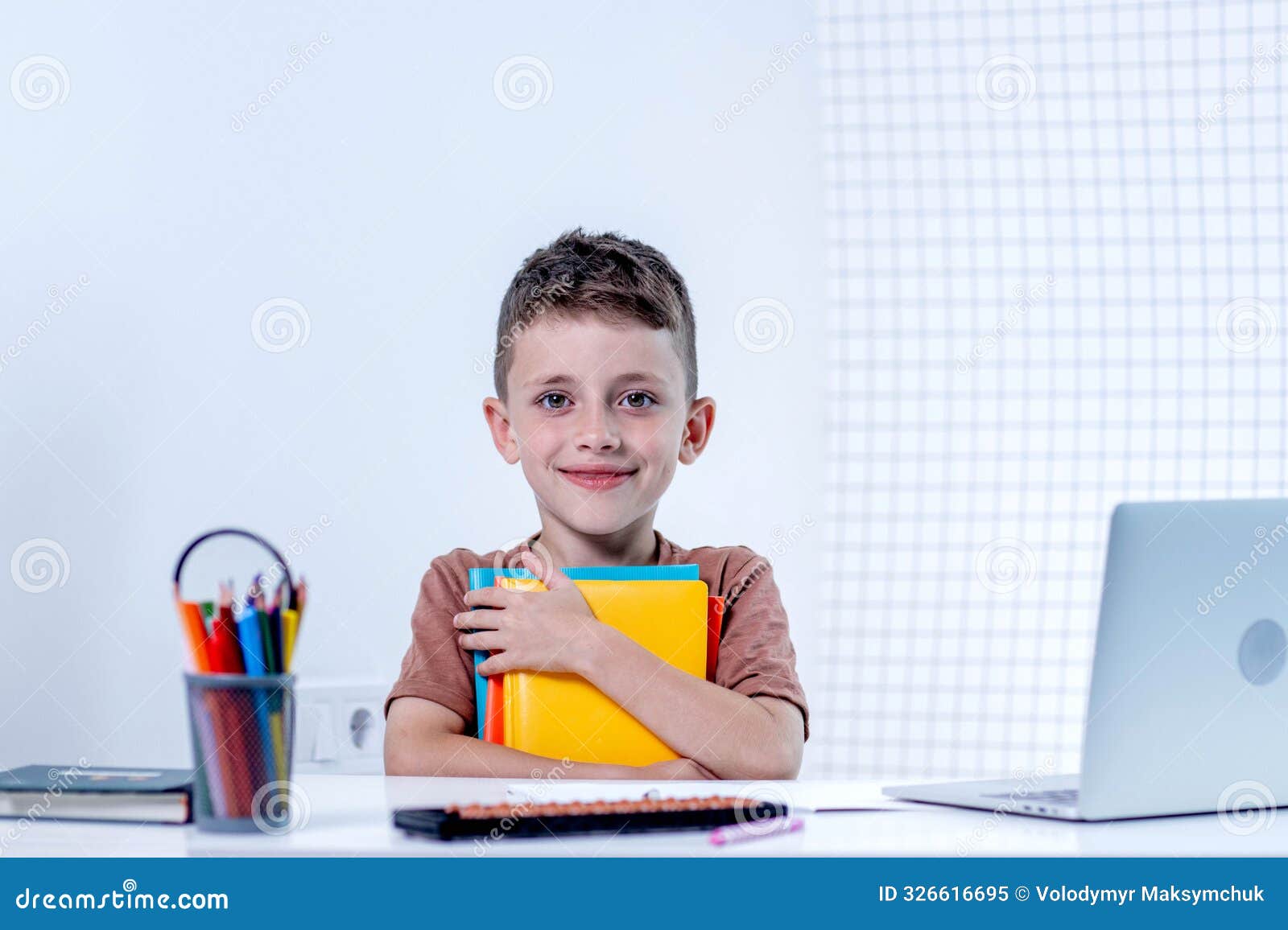 Smart Schoolboy is Ready To Study at a Neat Table in a White Interior ...