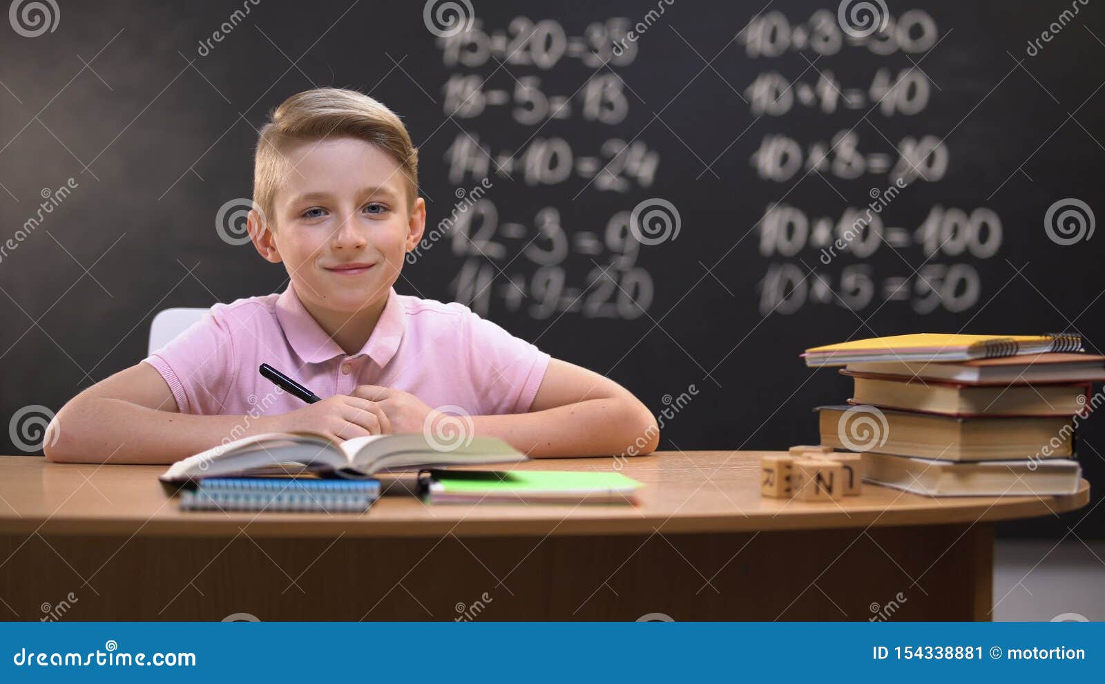 Smart Schoolboy Smiling To Camera after Solving Task, Exercises Written ...