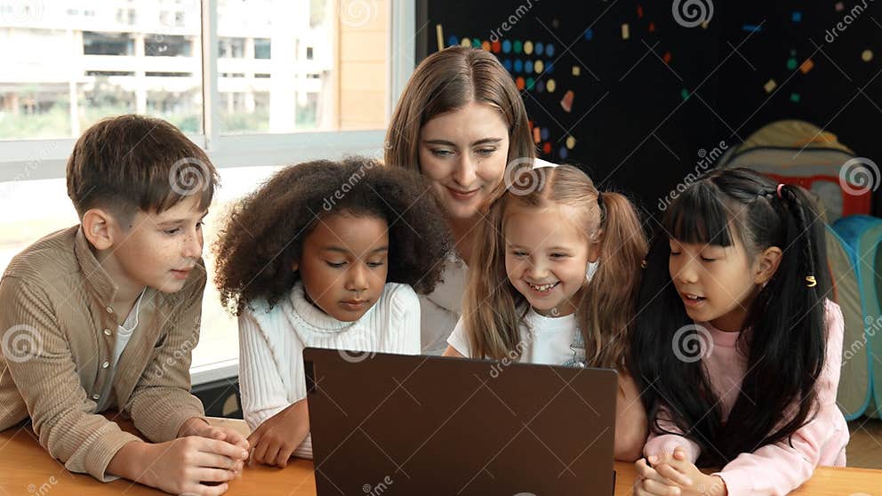 Caucasian Teacher Checking Student Answer while Learner Using Laptop ...