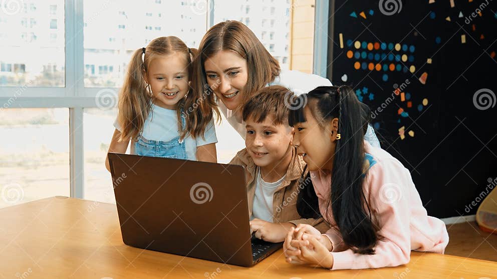 Caucasian Teacher Checking Student Answer while Learner Using Laptop ...