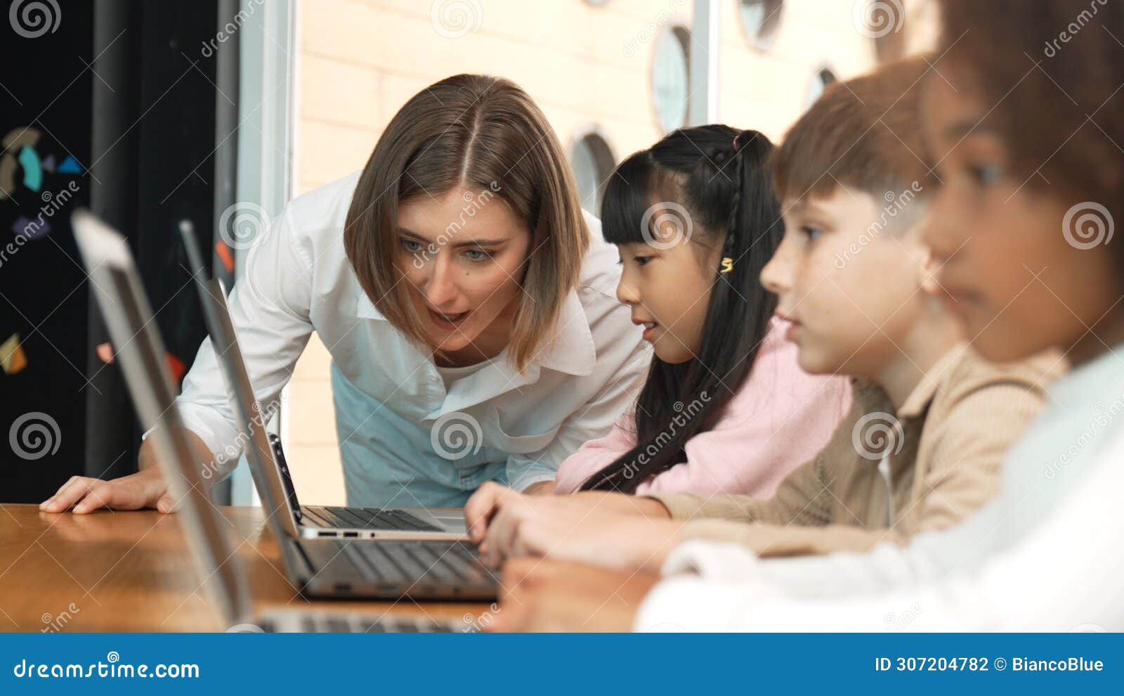 Smart Teacher Teaching and Looking Student Using Laptop at Classroom ...