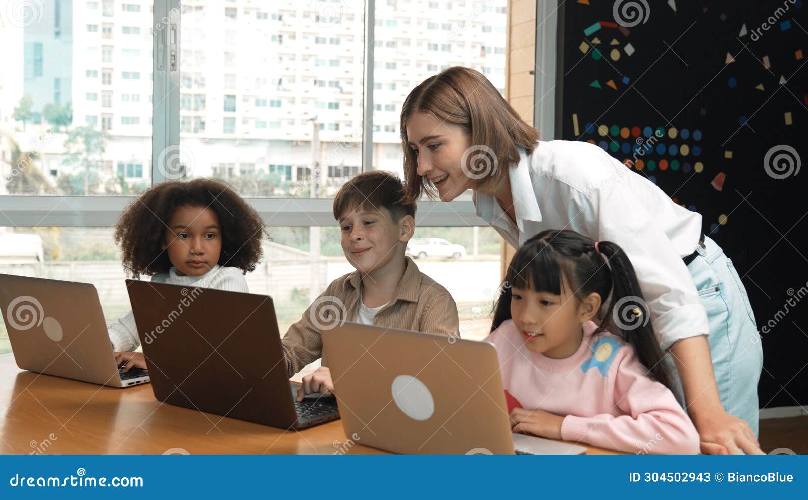 Smart Teacher Teaching and Looking Student Using Laptop at Classroom ...