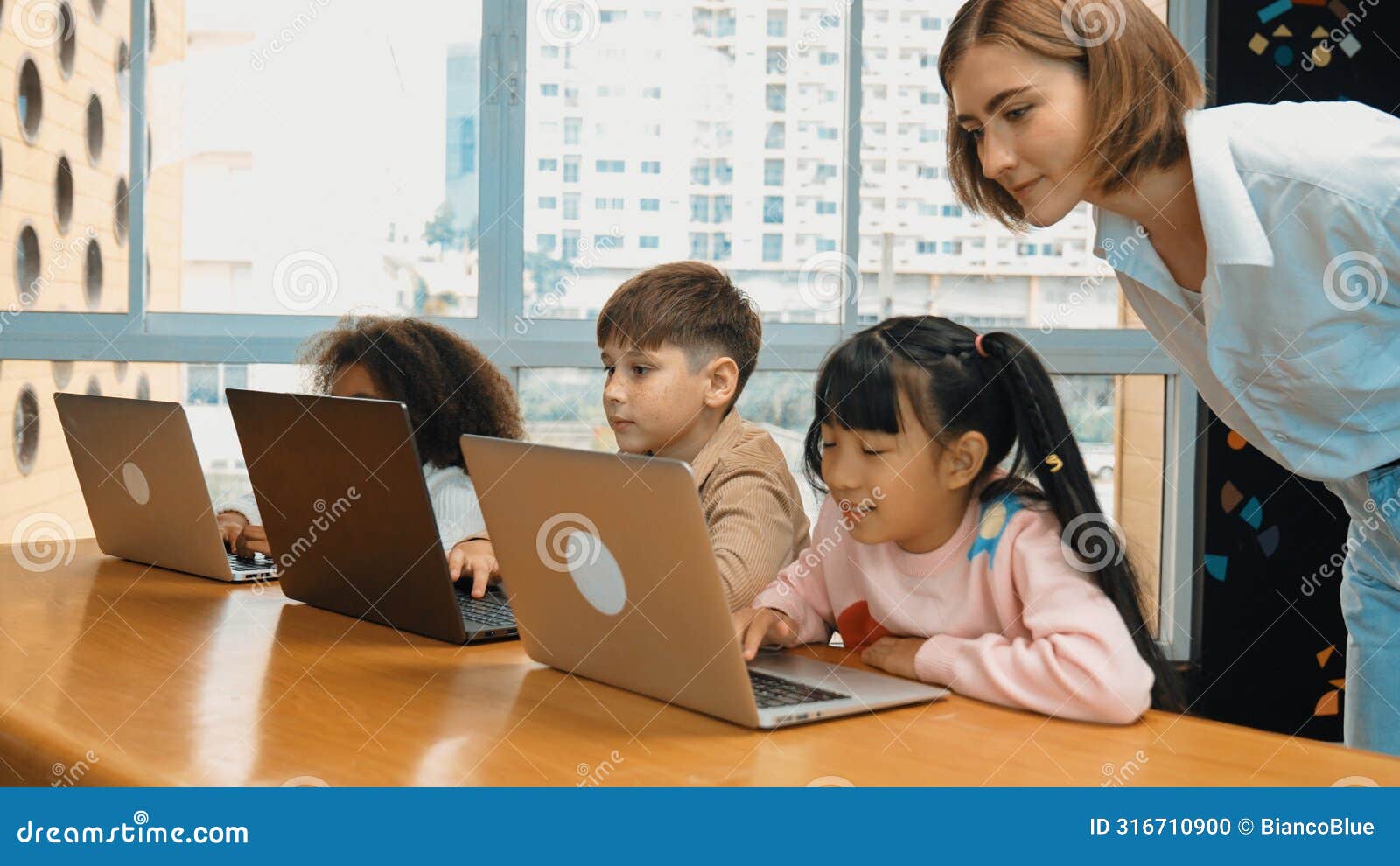 Smart Teacher Teaching and Looking Student Using Laptop at Classroom ...
