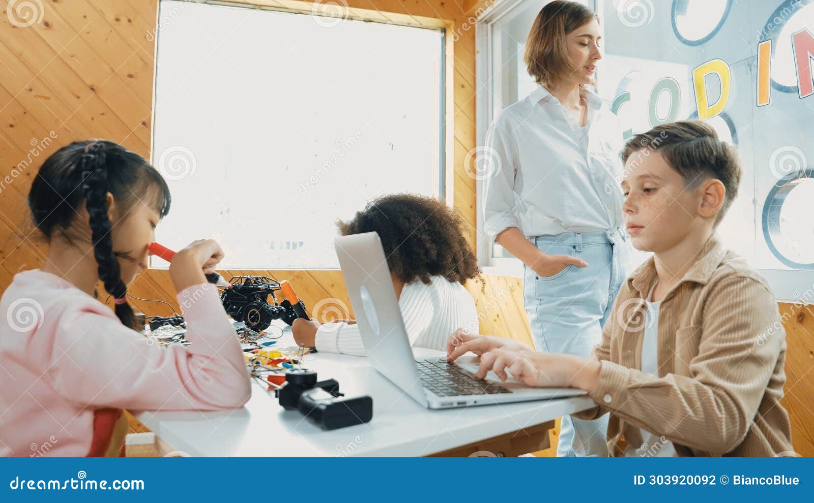 Smart Teacher Teaching and Looking Student Using Laptop at Classroom ...