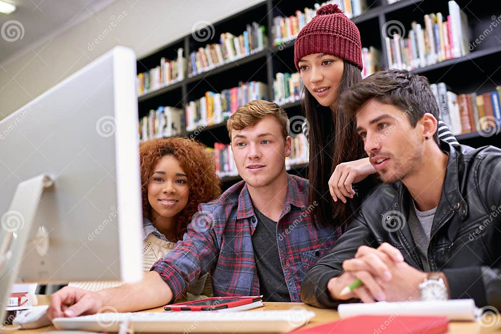 Smart Teamwork. a Group of Students Working Together at a Computer in a ...