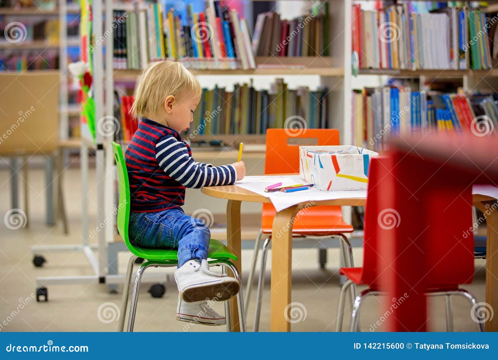 Smart Todller Boy, Educating Himself in a Library, Reading Books Stock ...