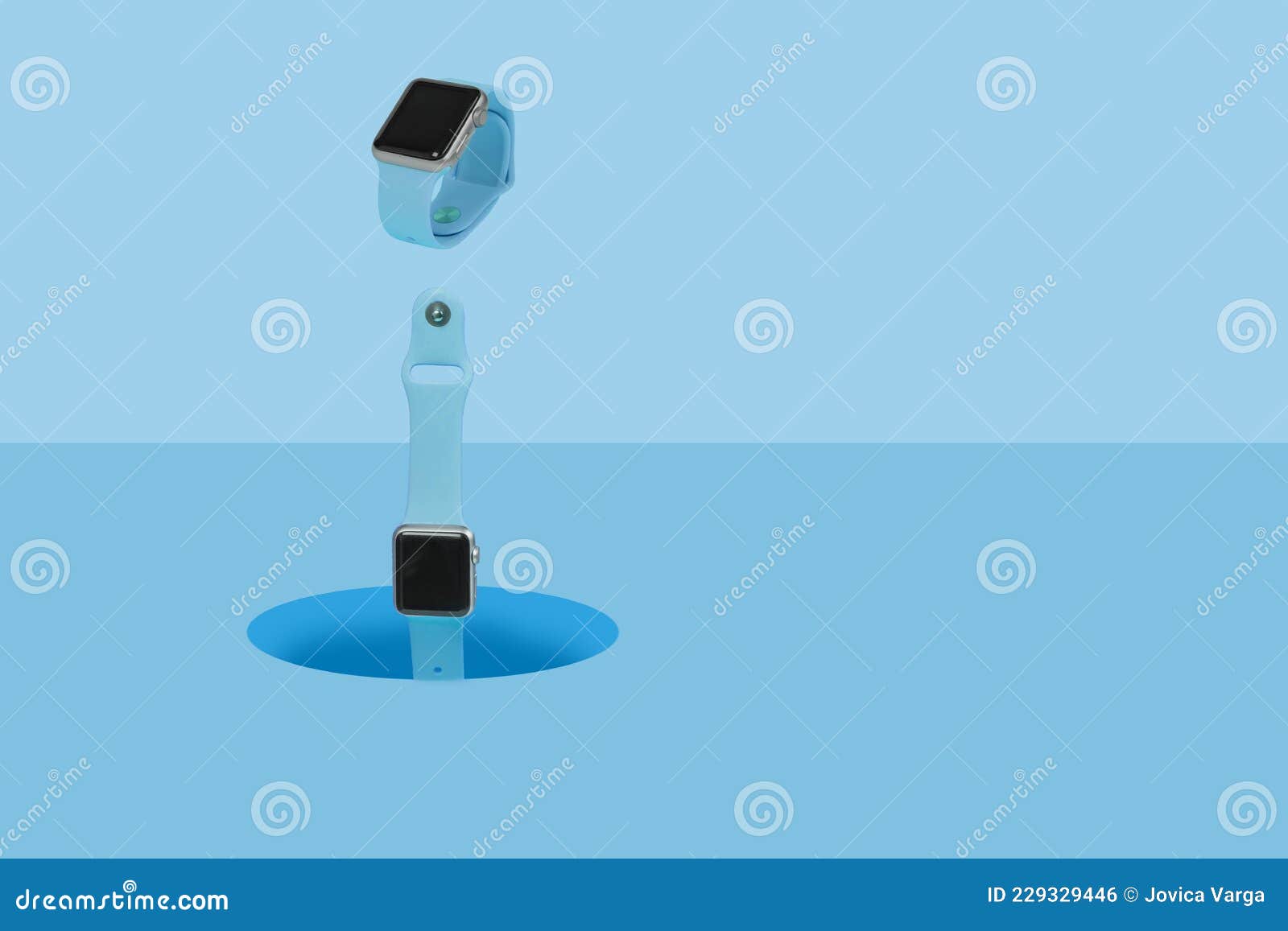 Smart Watch Falling into a Hole on Pastel Blue Background Stock Photo ...