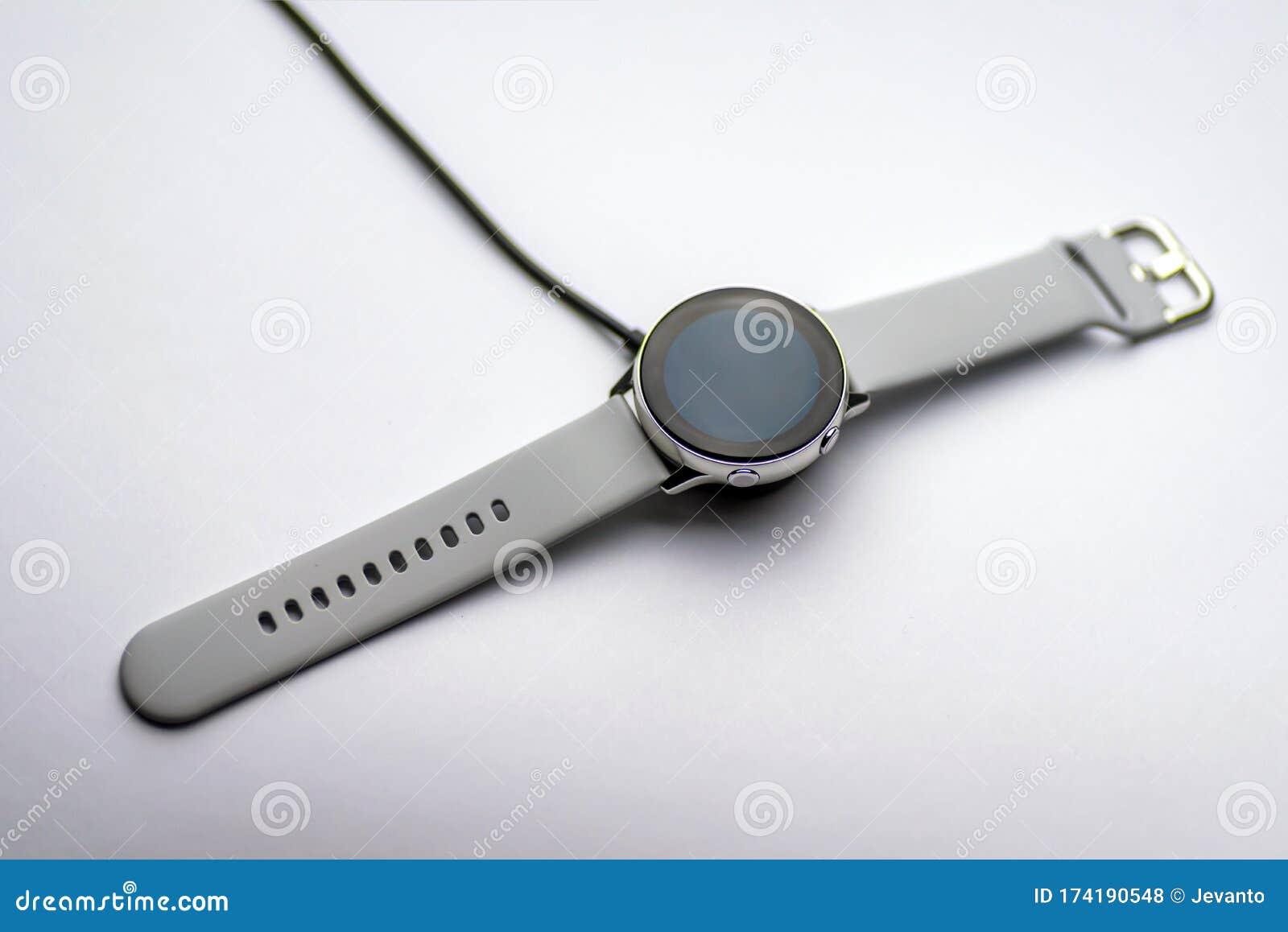 Smart Watch Wireless Charging on Charging Pad on Kitchen Worktop Table ...