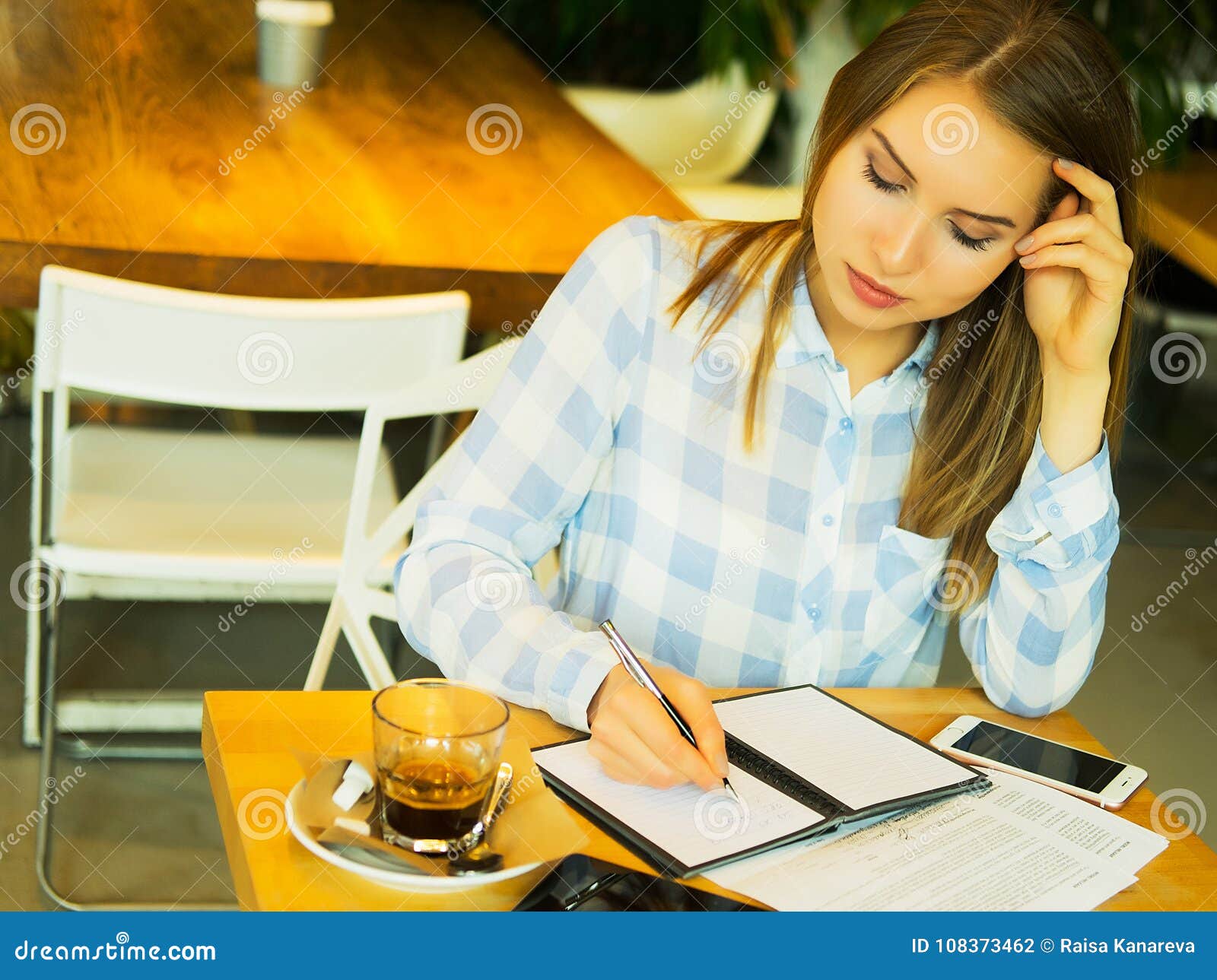 Smart Woman Writing Down Her Ideas and Drinking Coffe in Cafe Stock ...