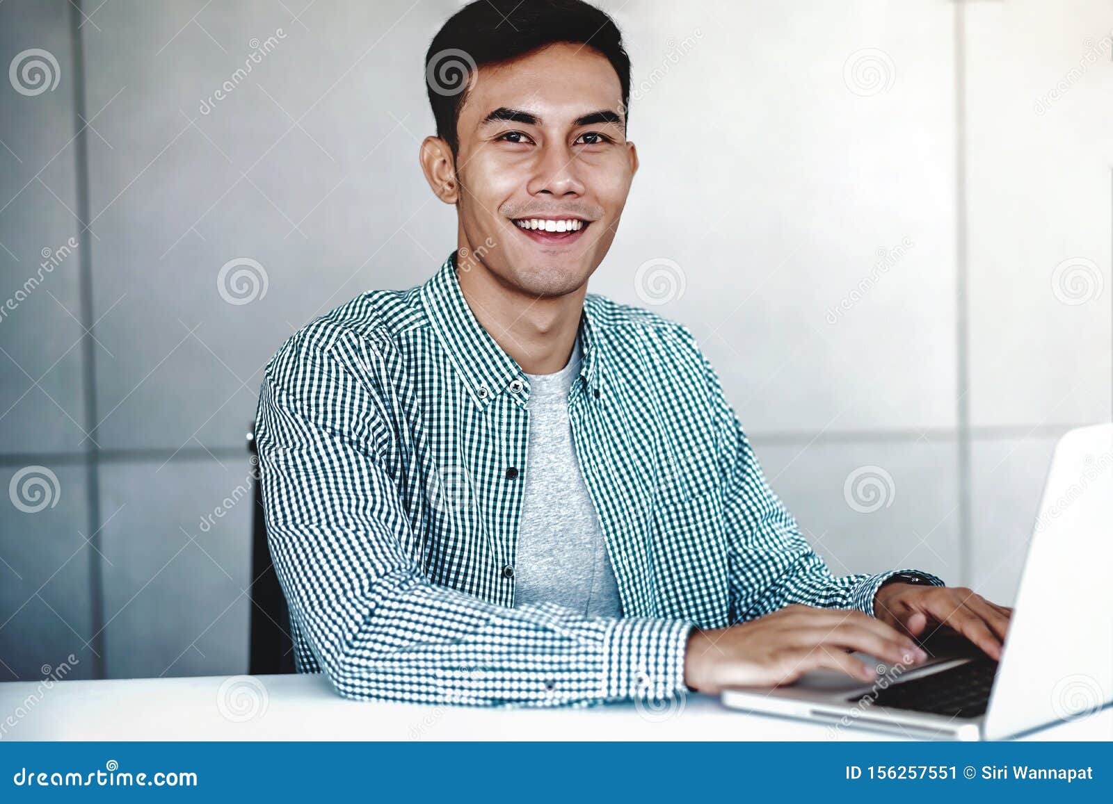 Smart Young Asian Businessman Working on Computer Laptop in Office ... Smart Young Asian Businessman Working on Computer Laptop in Office ...
