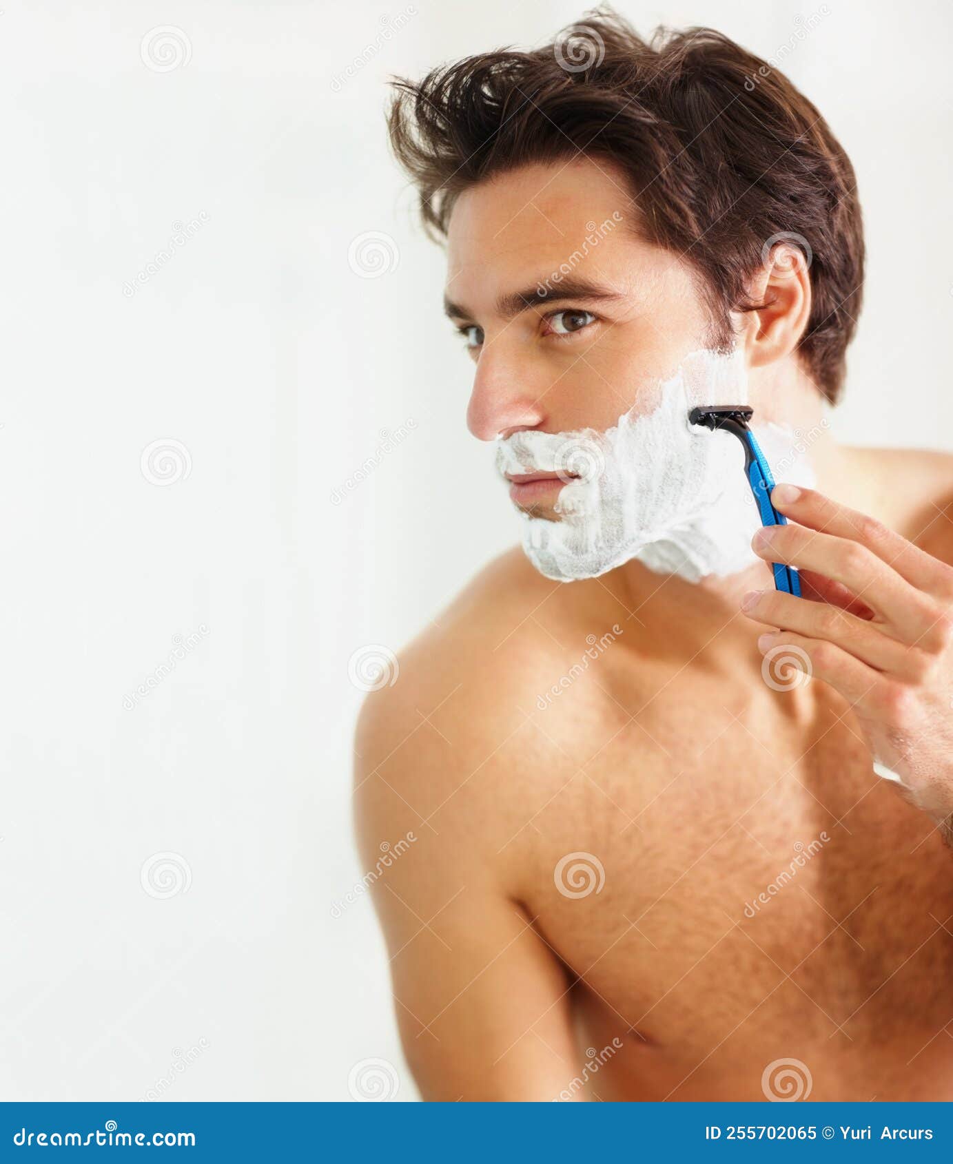 Smart Young Guy Using a Razor To Shave. Portrait of a Young Handsome ...