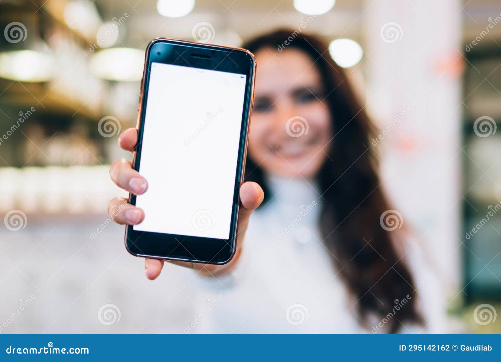 Smart Young Woman Showing Cellphone in Studio Stock Photo - Image of ...